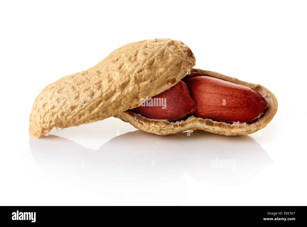 Cracked peanuts on white background Stock Photo - Alamy