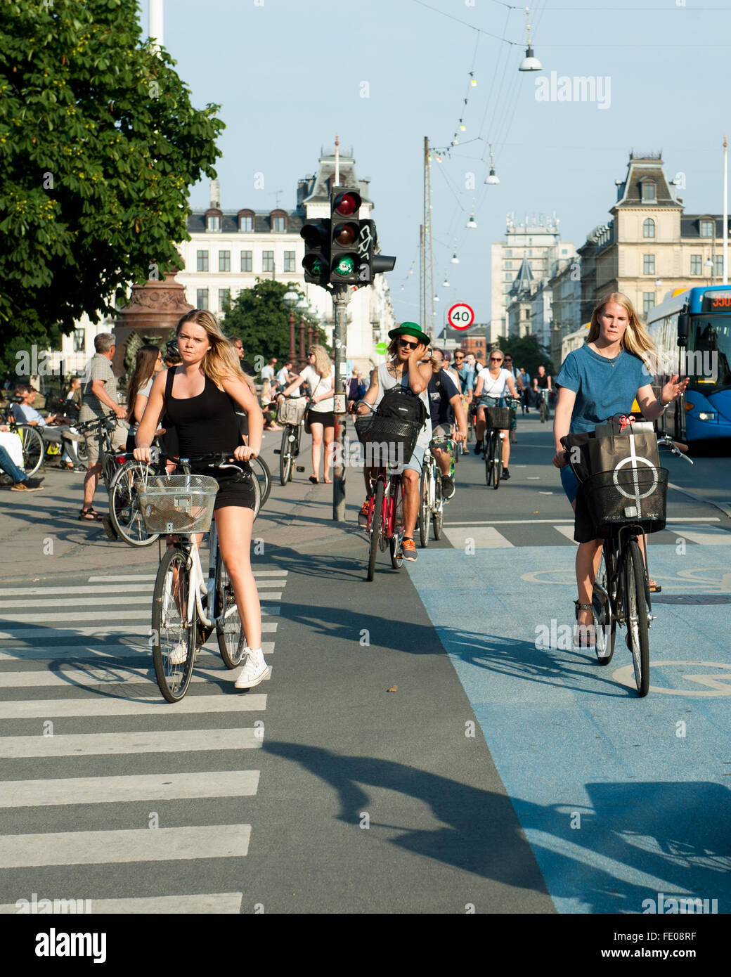 Young Danes riding bikes around town on Dronning Louises Bro in sunny ...