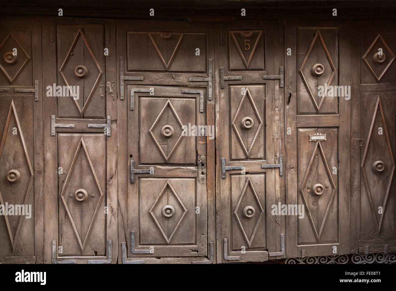 A traditional Spanish colonial hacienda style carved wooden door on a ...