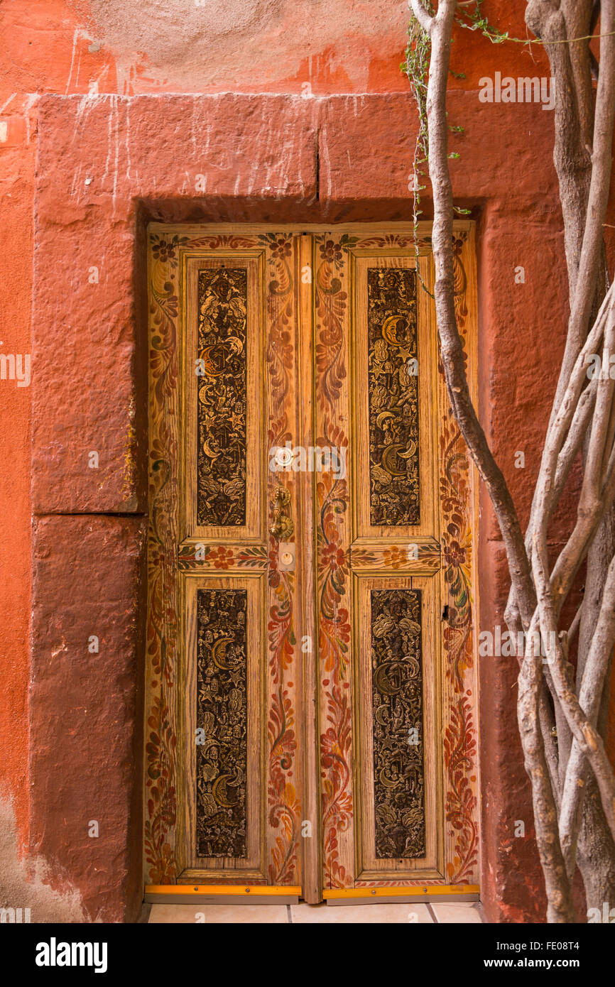 A traditional Spanish colonial hacienda style painted wooden door on a ...