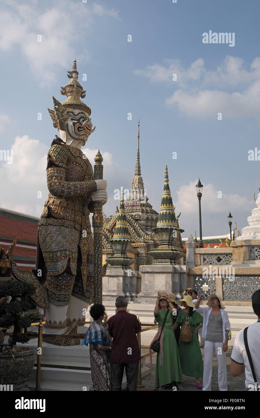 White giant temple guardian statue with spires beyond, The Grand Palace ...