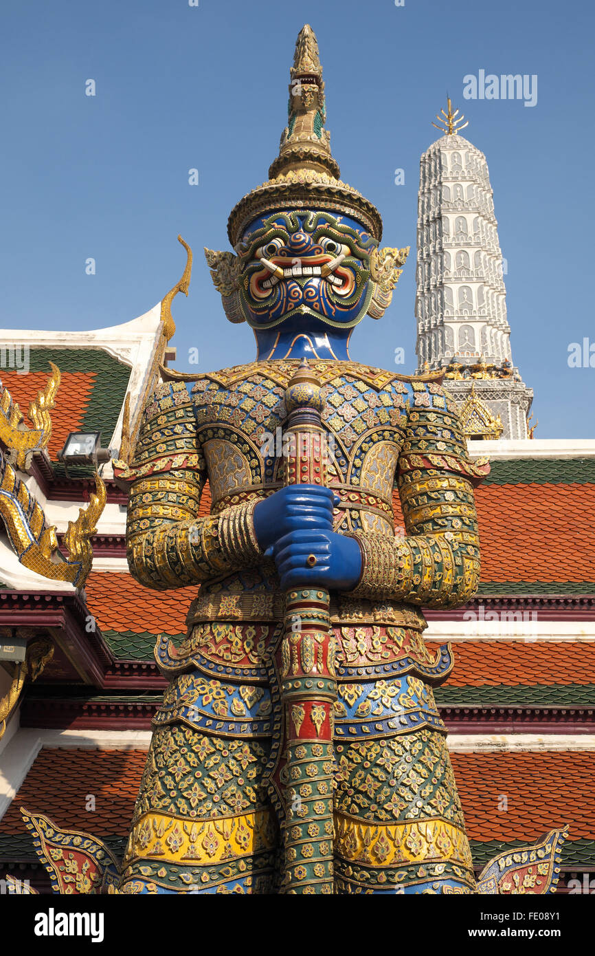 Blue giant temple guardian statue with roof of Hor Phra Gandhararat and ...