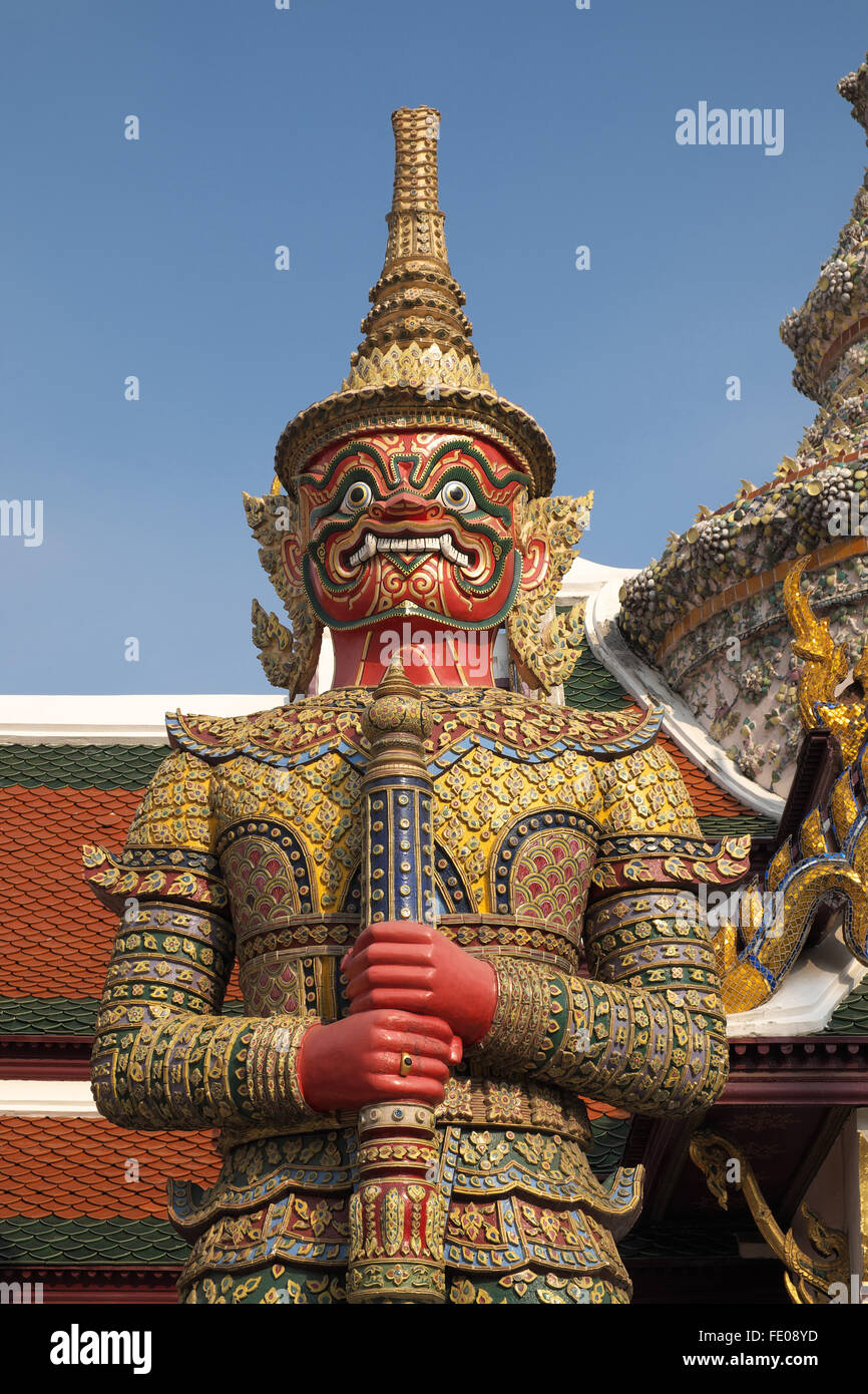 Red giant temple guardian with roof of Hor Phra Gandhararat beyond, The ...