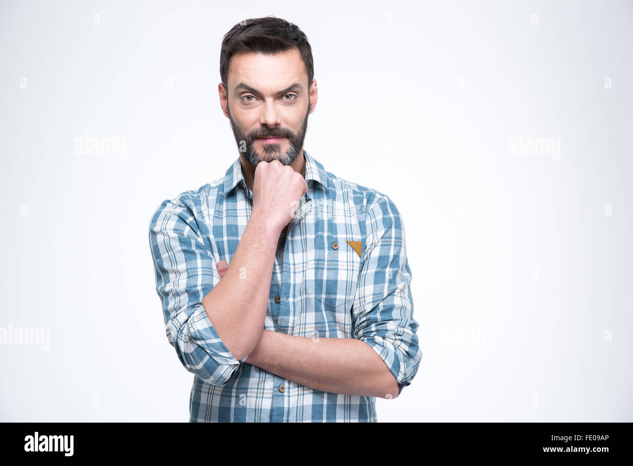 Handsome serious man looking at camera isolated on a white background ...