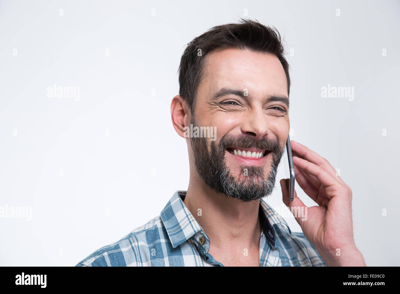 Happy man talking on the phone isolated on a white background Stock ...