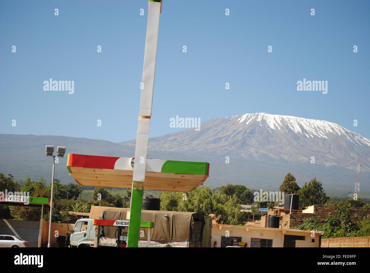 a great shot of of Mt. Kilimanjaro and a Petrol gas filling station at ...