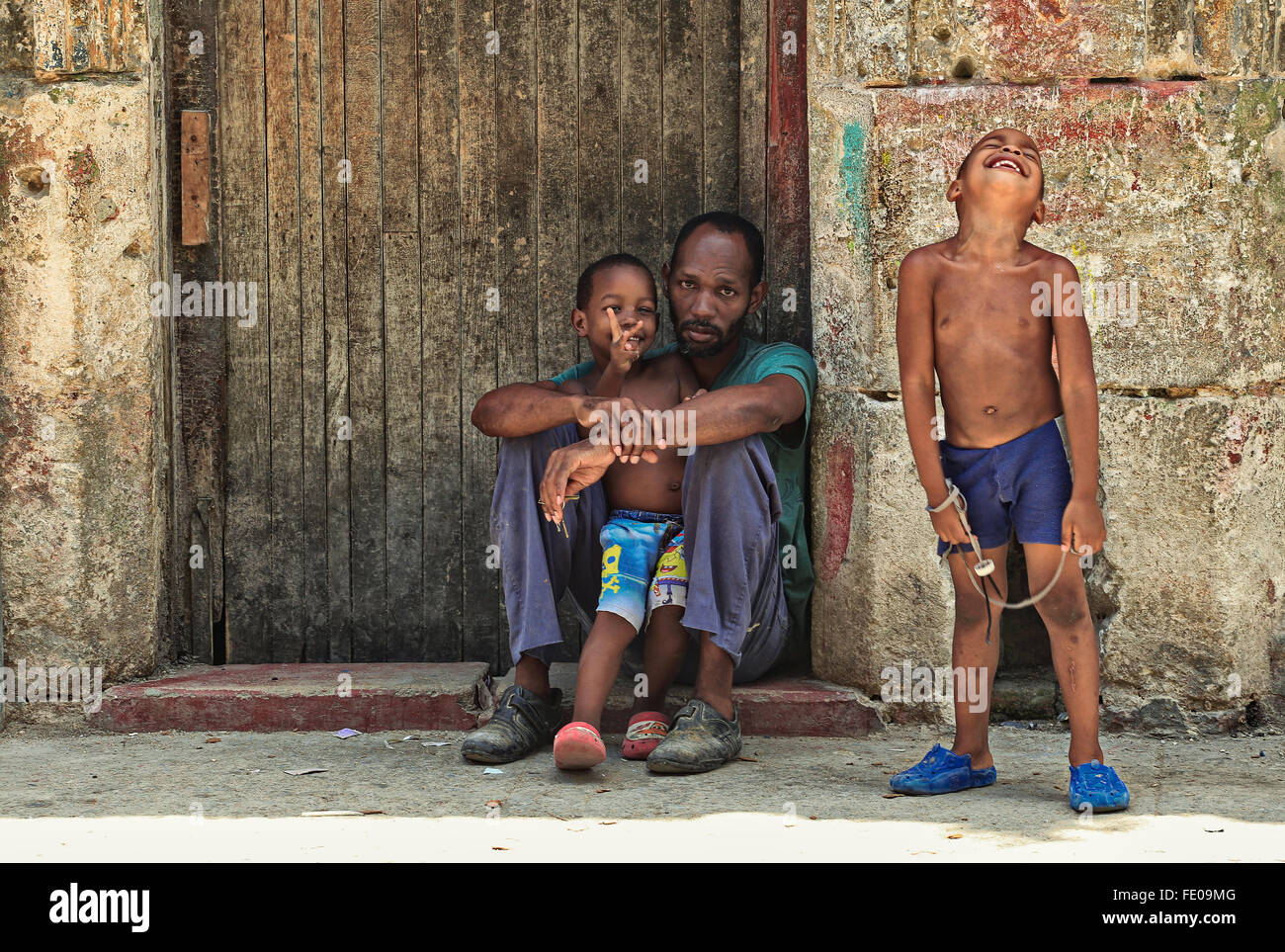 Tired father and two young sons, rest on the street of old Havana,Cuba ...