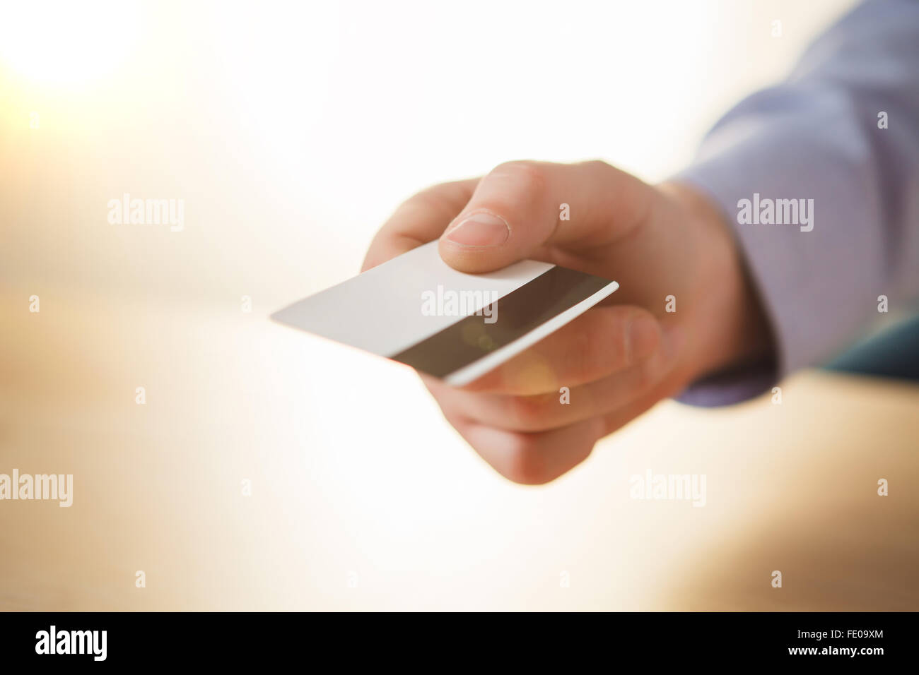 The male hand showing credit card on the background of table Stock ...