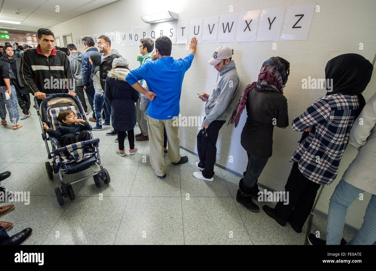 Refugees wait for food to be distributed in a former Neckermann ...