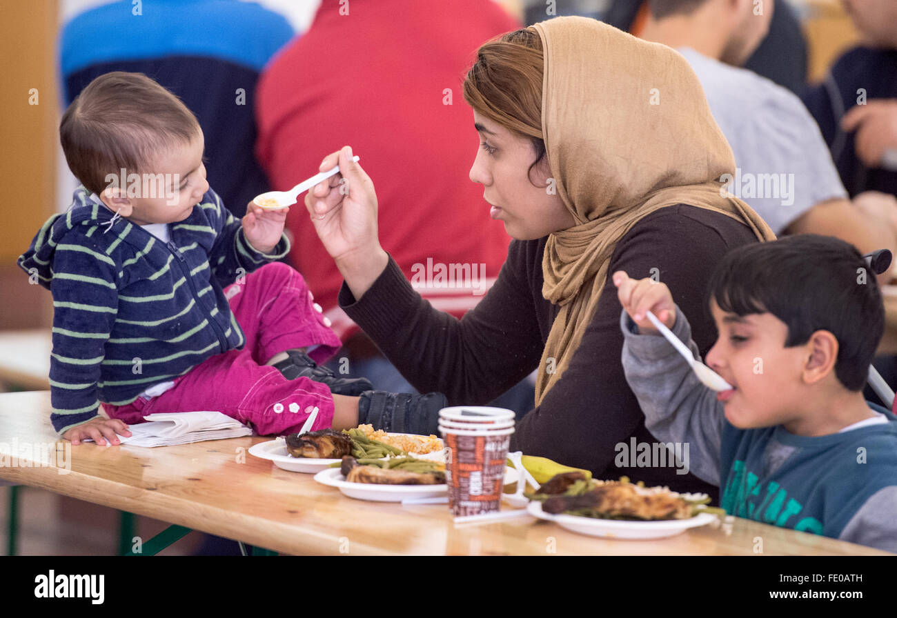 A mother feeds her child in a former Neckermann building, which has ...