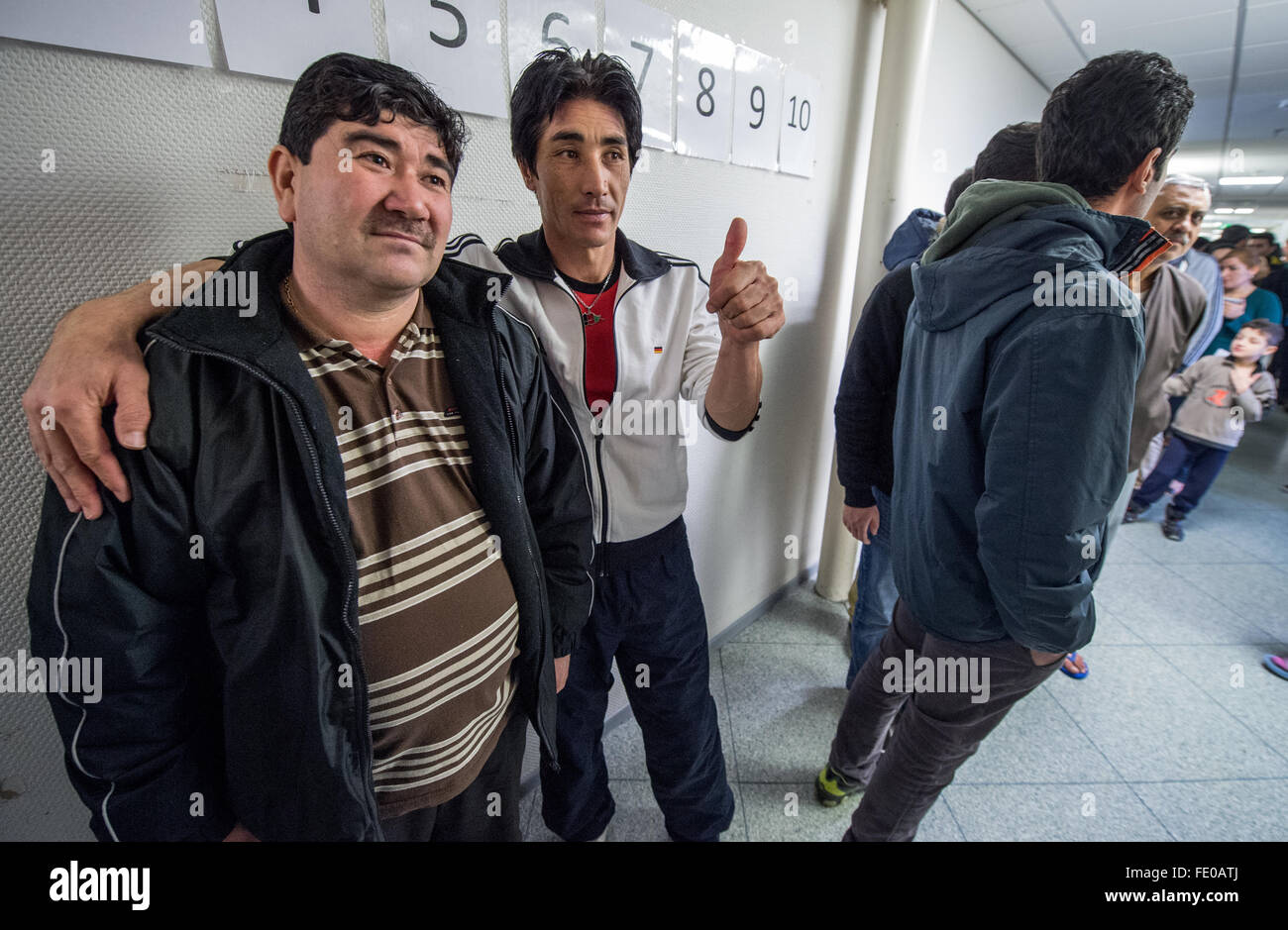 Refugees wait for food to be distributed in a former Neckermann ...