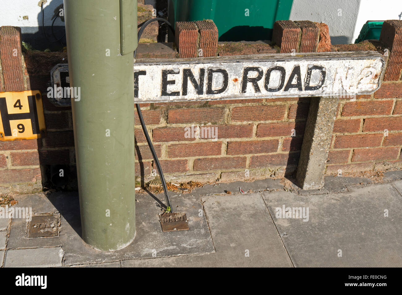 Lamp post obscuring road sign in East Finchley, London Stock Photo - Alamy