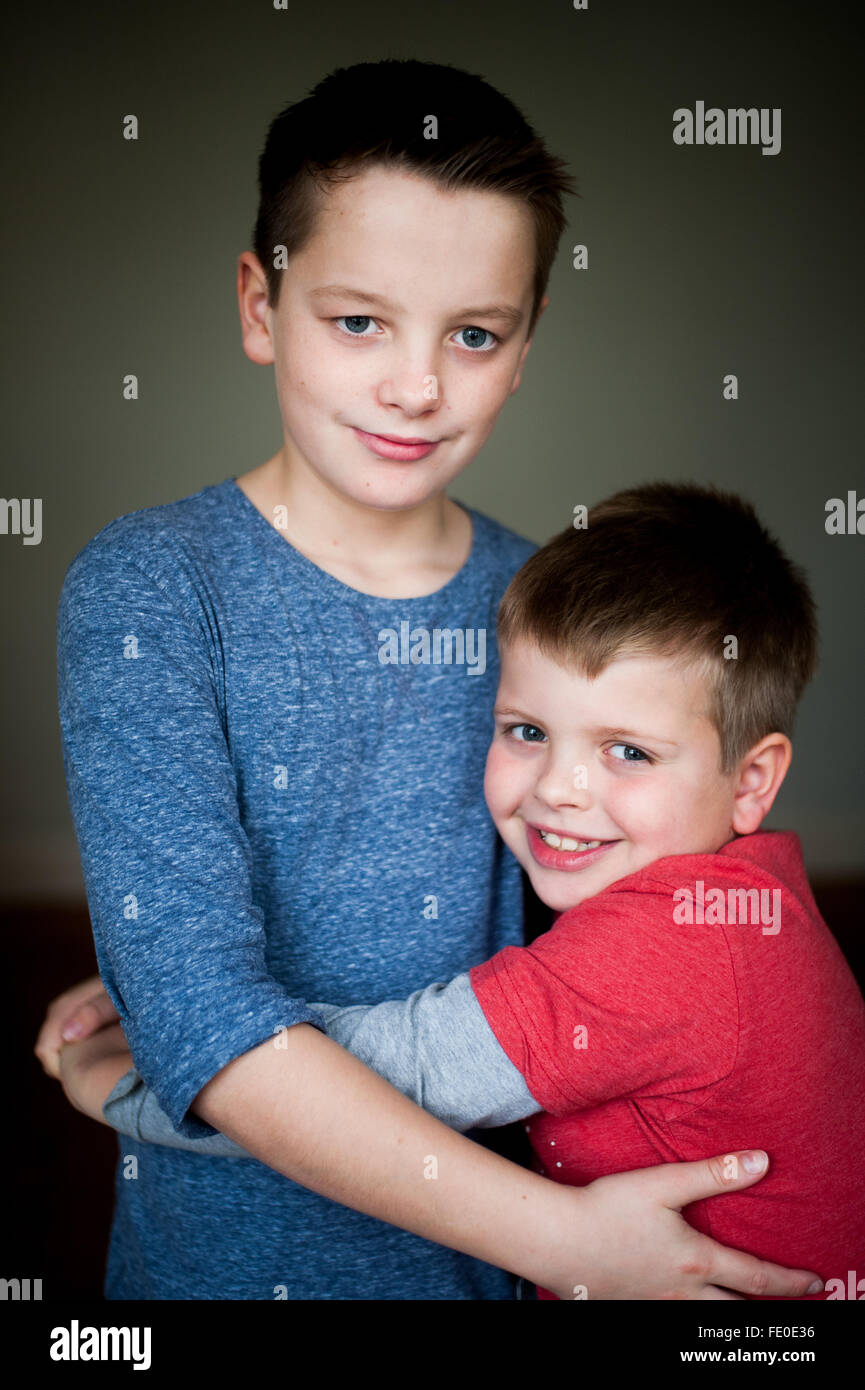 2 brothers aged 9 and 12 hugging and smiling Stock Photo - Alamy