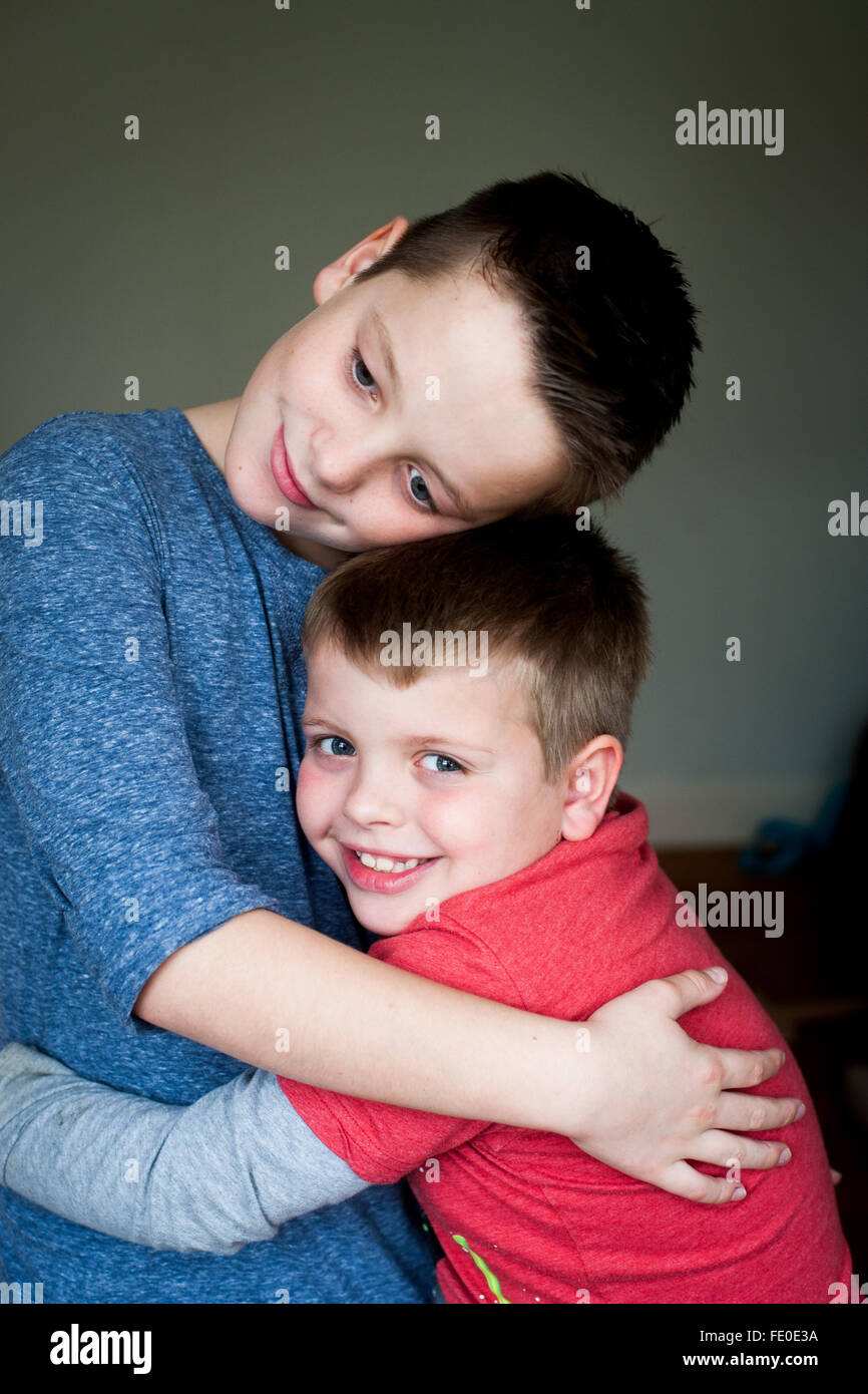 2 brothers aged 9 and 12 hugging and smiling Stock Photo - Alamy