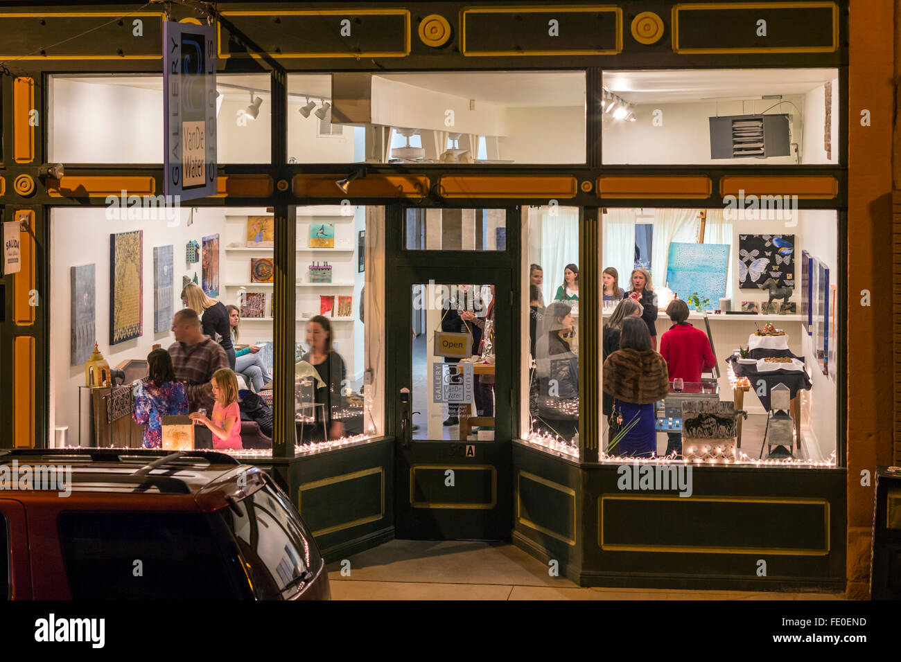 Night view of artist gallery opening event in small mountain town of ...