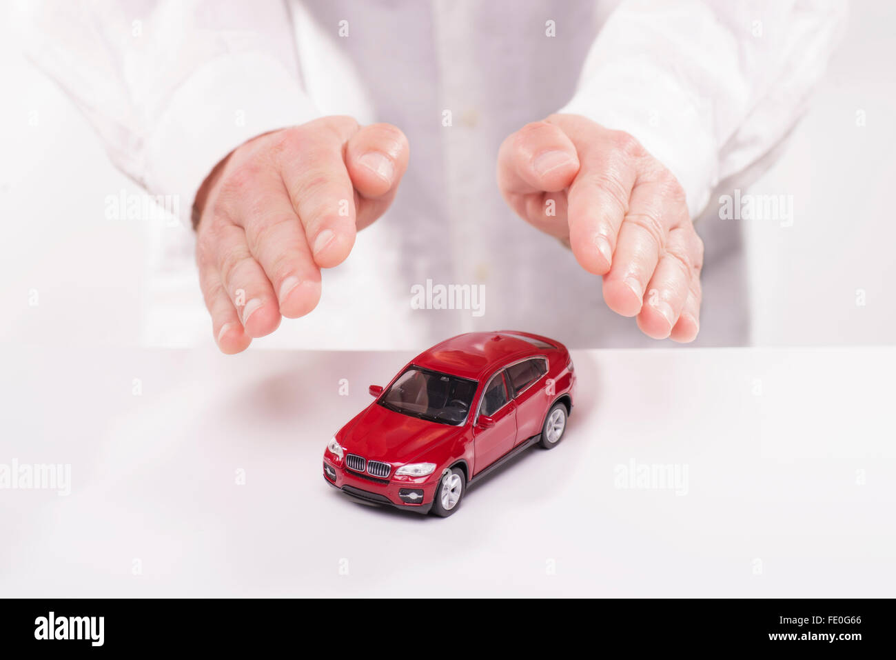 Hands are held protectively over a car Stock Photo - Alamy