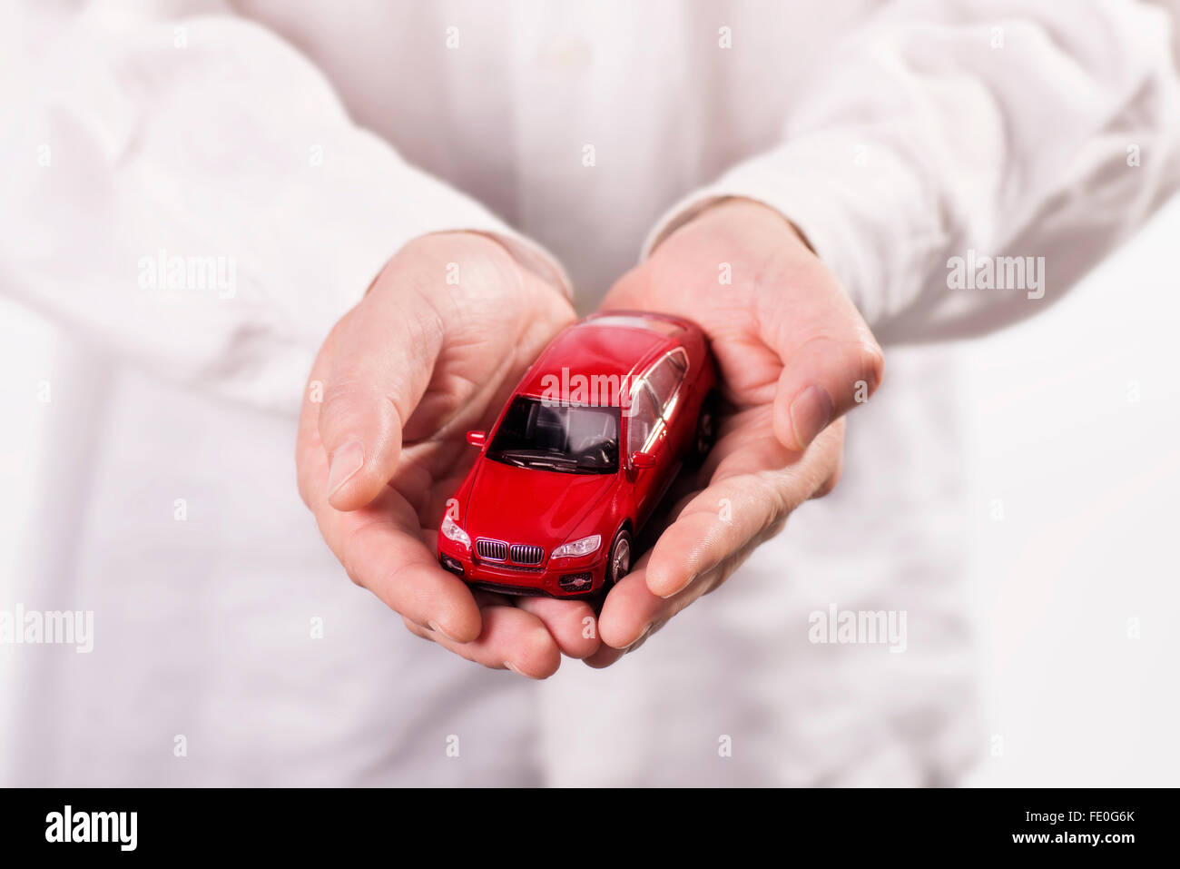 Hands holding a car Stock Photo - Alamy