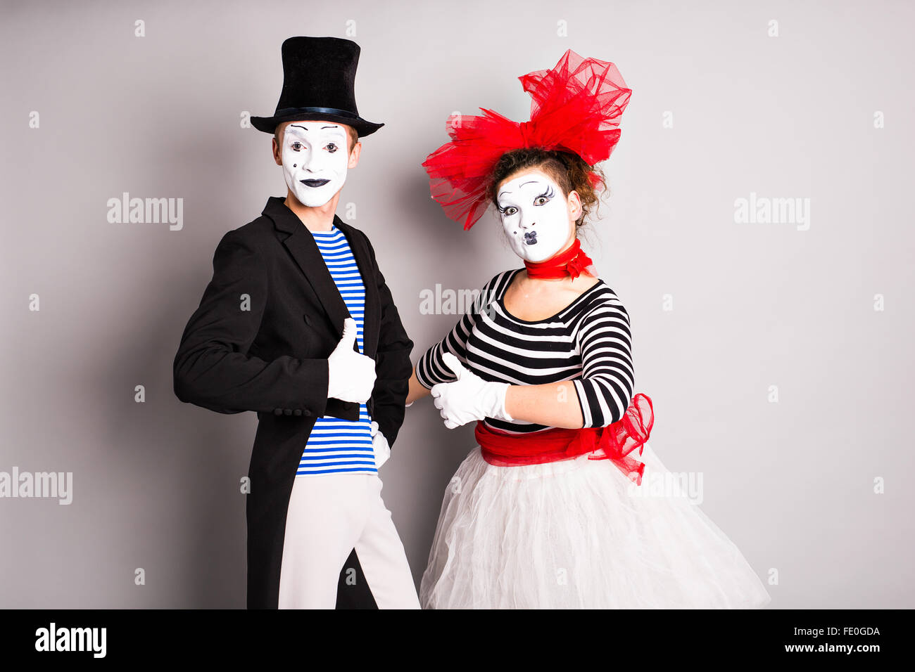 Portrait of a two happy mimes comedian showing thumbs up, April Fools ...