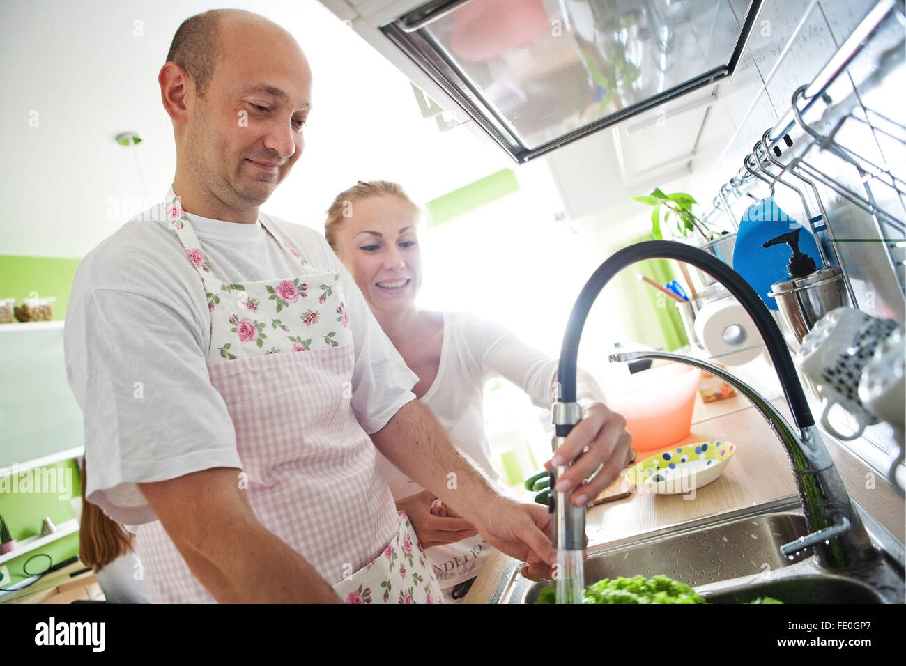 man and woman washing dishes, vegetables Stock Photo - Alamy