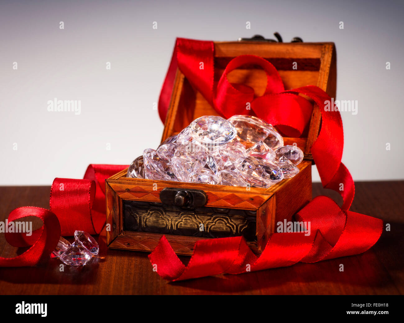 Many diamonds in a treasure chest with a red ribbon Stock Photo - Alamy