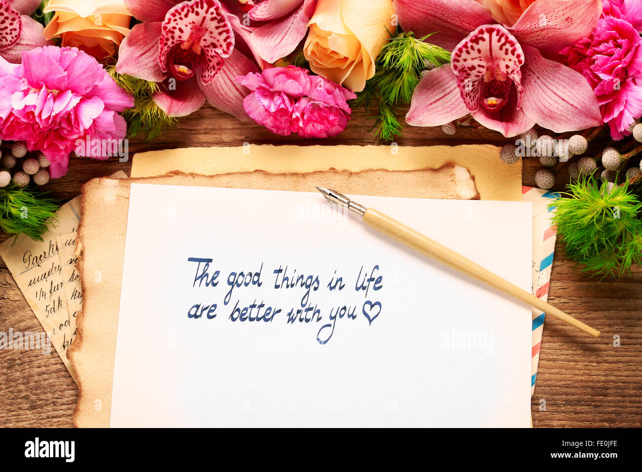 Floral arrangement with orchids, roses and handwritten words on vintage ...