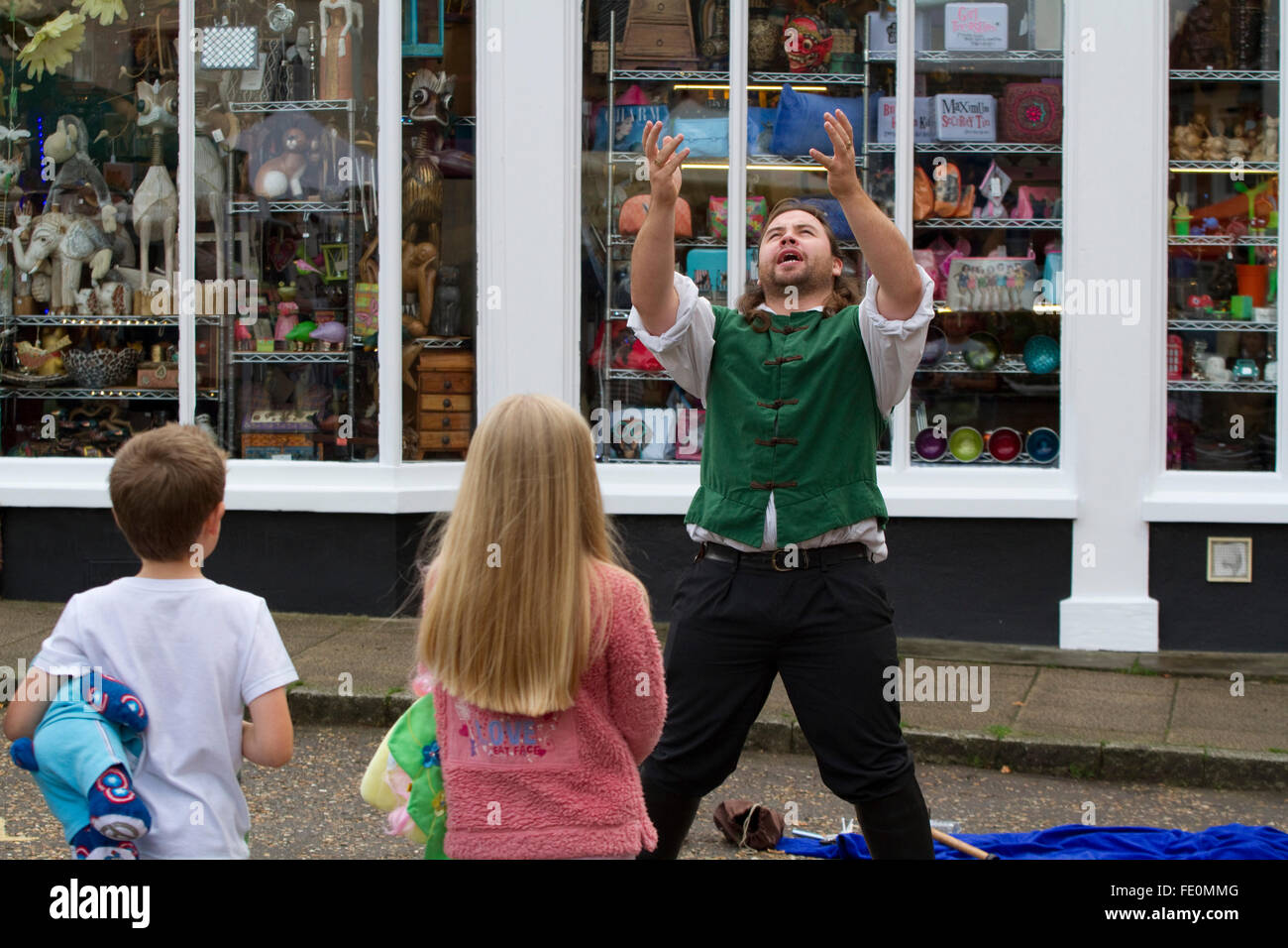 Street performer juggling looks like a dramatic gesture Stock Photo - Alamy