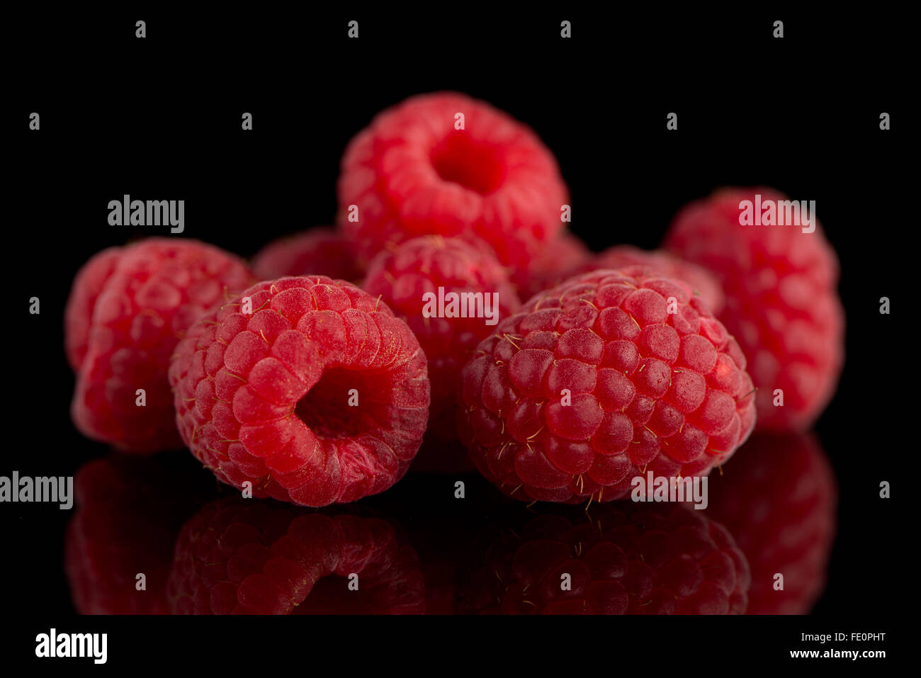 Raspberries with leaves isolated on black background background Stock ...