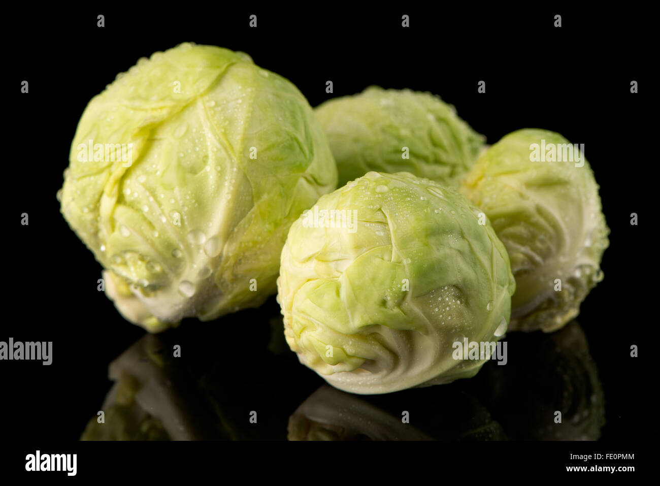 Fresh brussels sprouts isolated on black background Stock Photo - Alamy