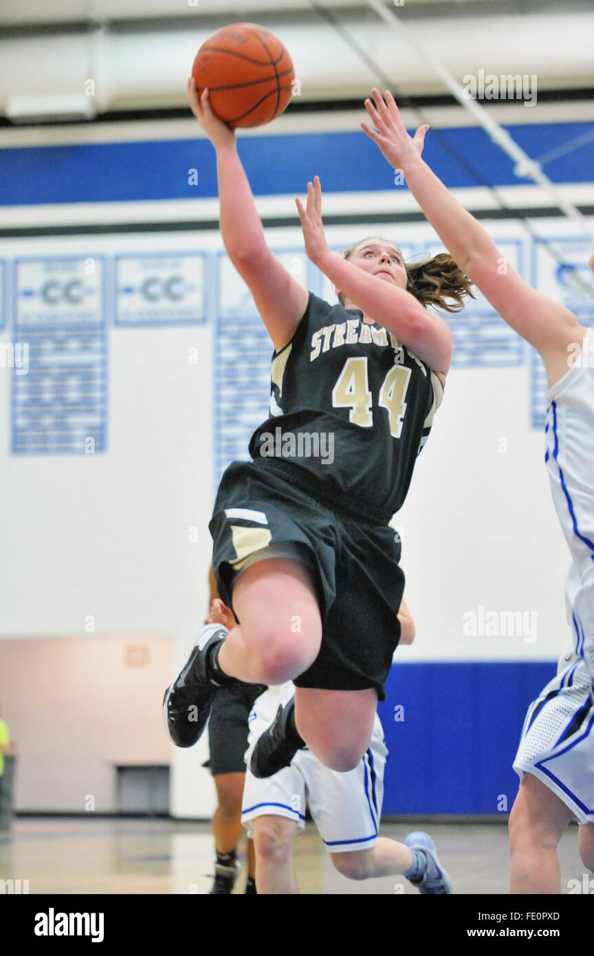 Player putting up an shot from under the basket during a high school ...