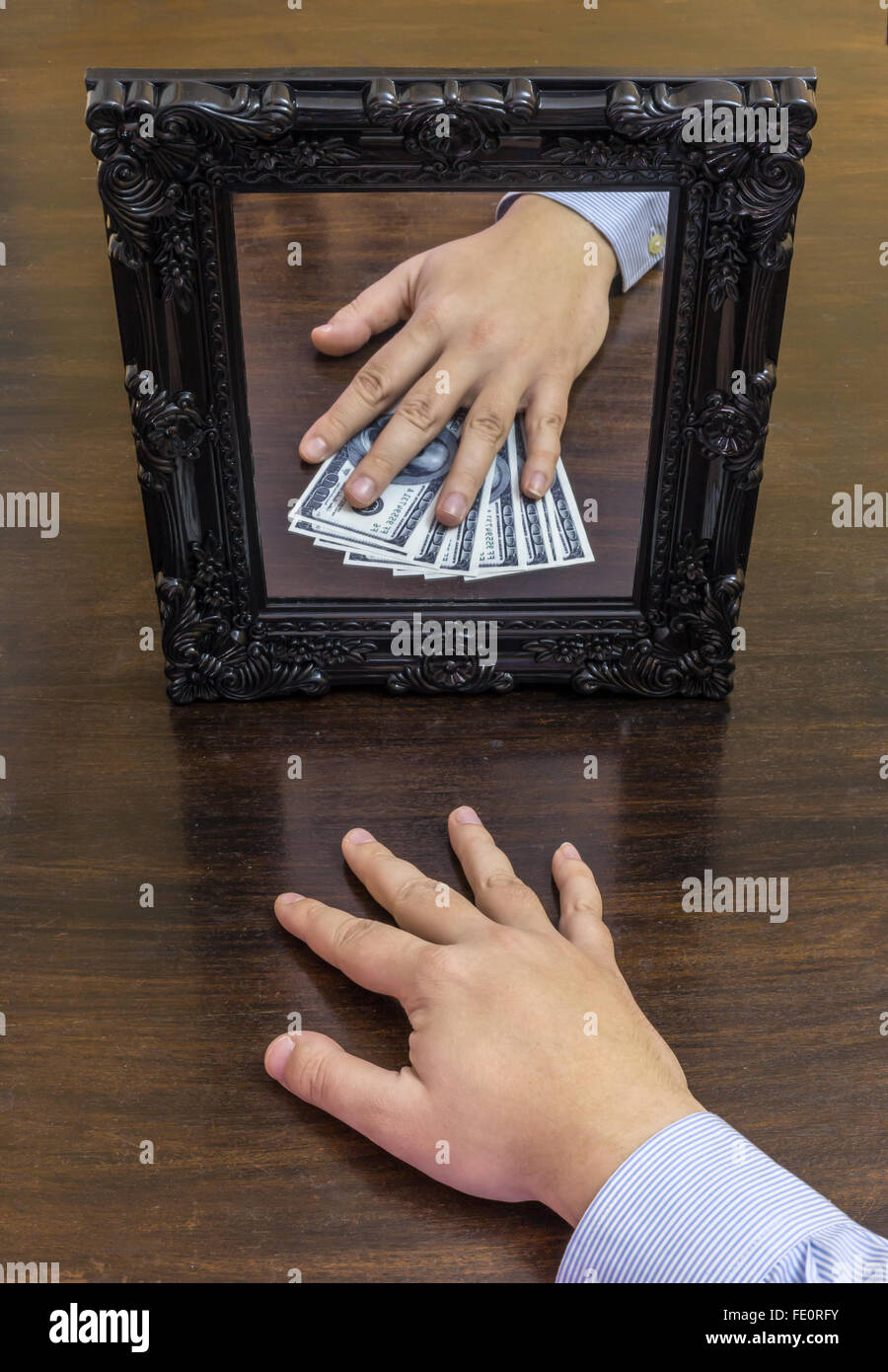 Reflection of a human hand holding money Stock Photo - Alamy