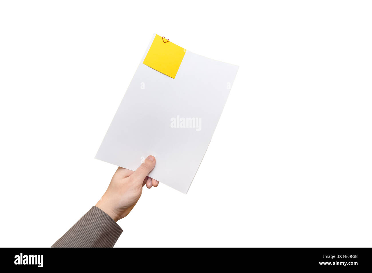 Human hand holding a sheet of paper with a yellow note on it. The note ...