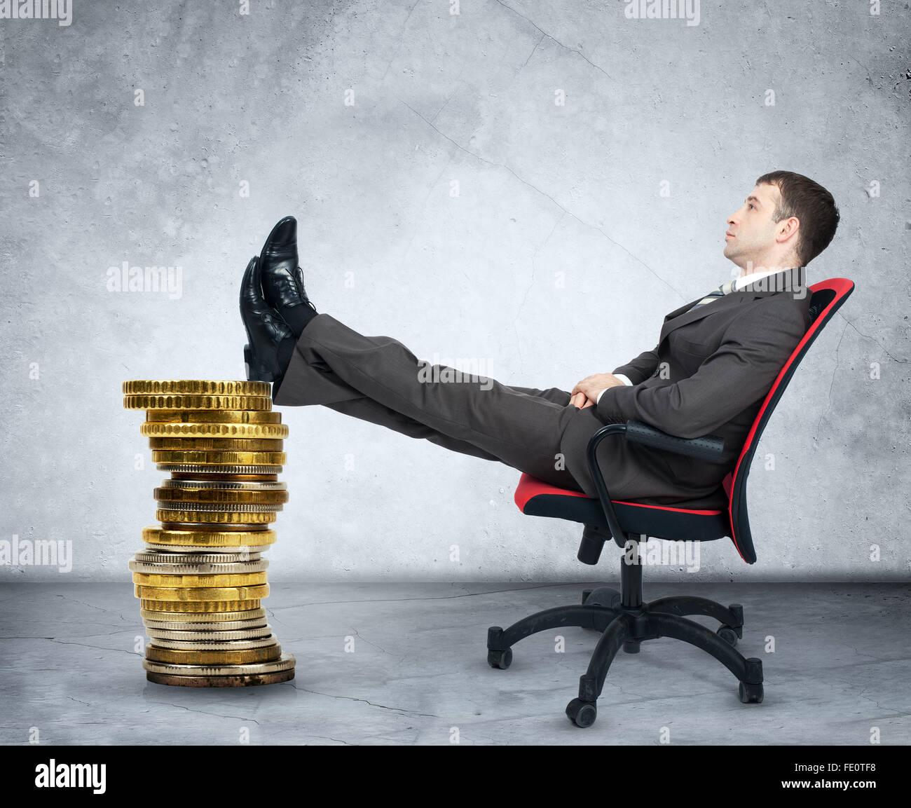 Businessman sitting on chair and pile of coins Stock Photo - Alamy