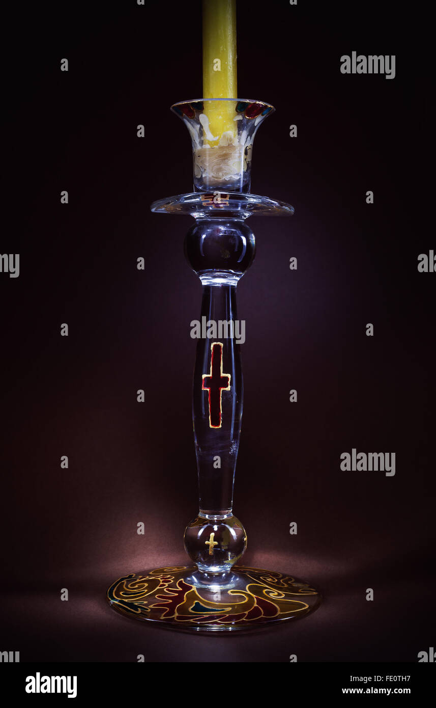 Candle on stand decorated with Christian symbols Stock Photo - Alamy
