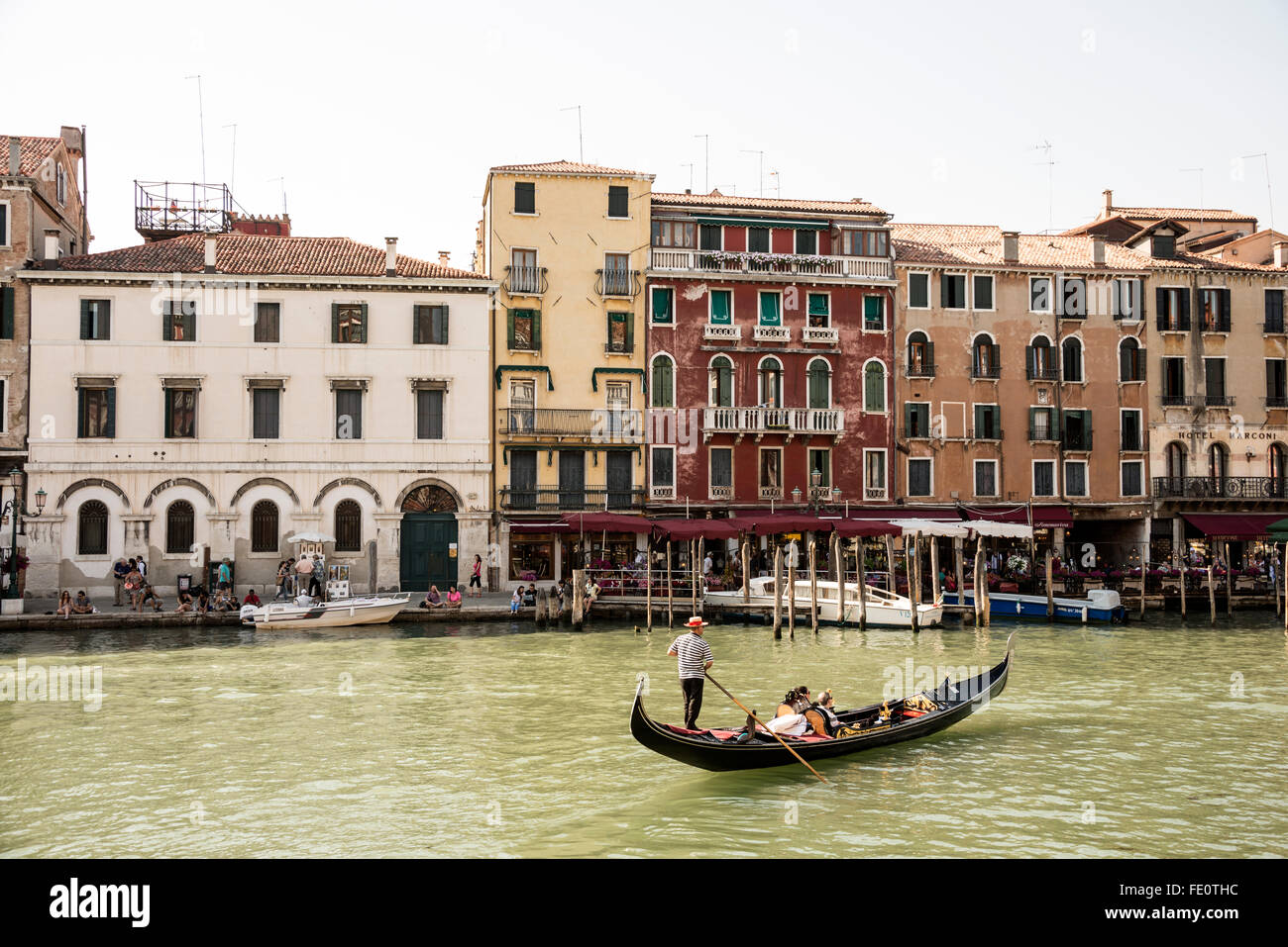 A gondoliere steers his gondola on the Grand Canal in central Venice in ...