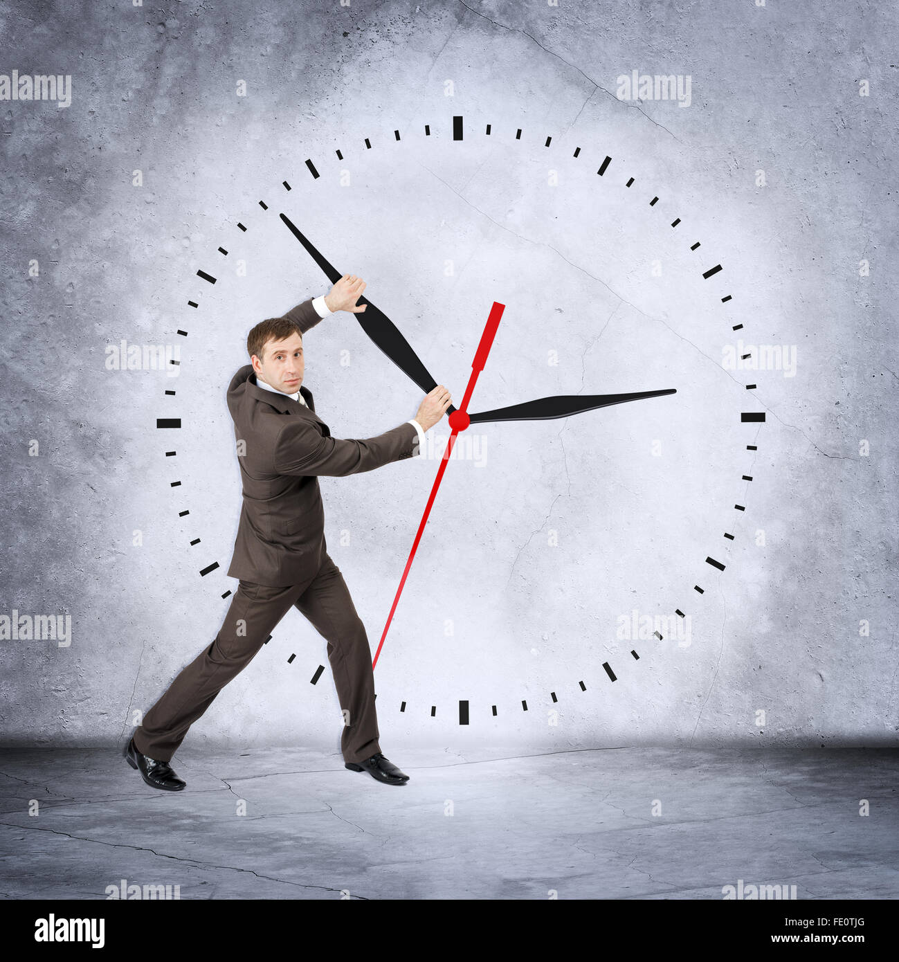 Businessman holding clock hand Stock Photo - Alamy