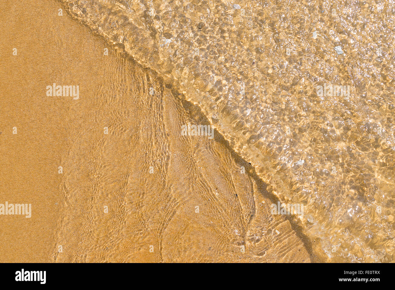 yellow sand of the sea shore waves Stock Photo - Alamy