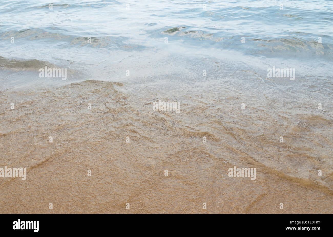 yellow sand of the sea shore waves Stock Photo - Alamy
