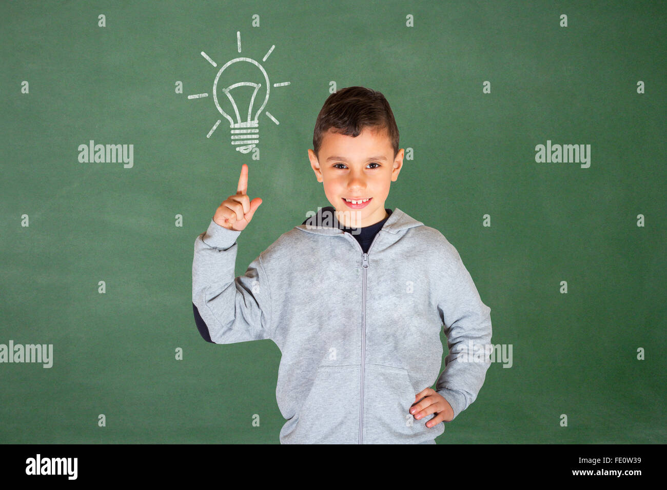 Cute boy pointing up to a light bulb Stock Photo - Alamy