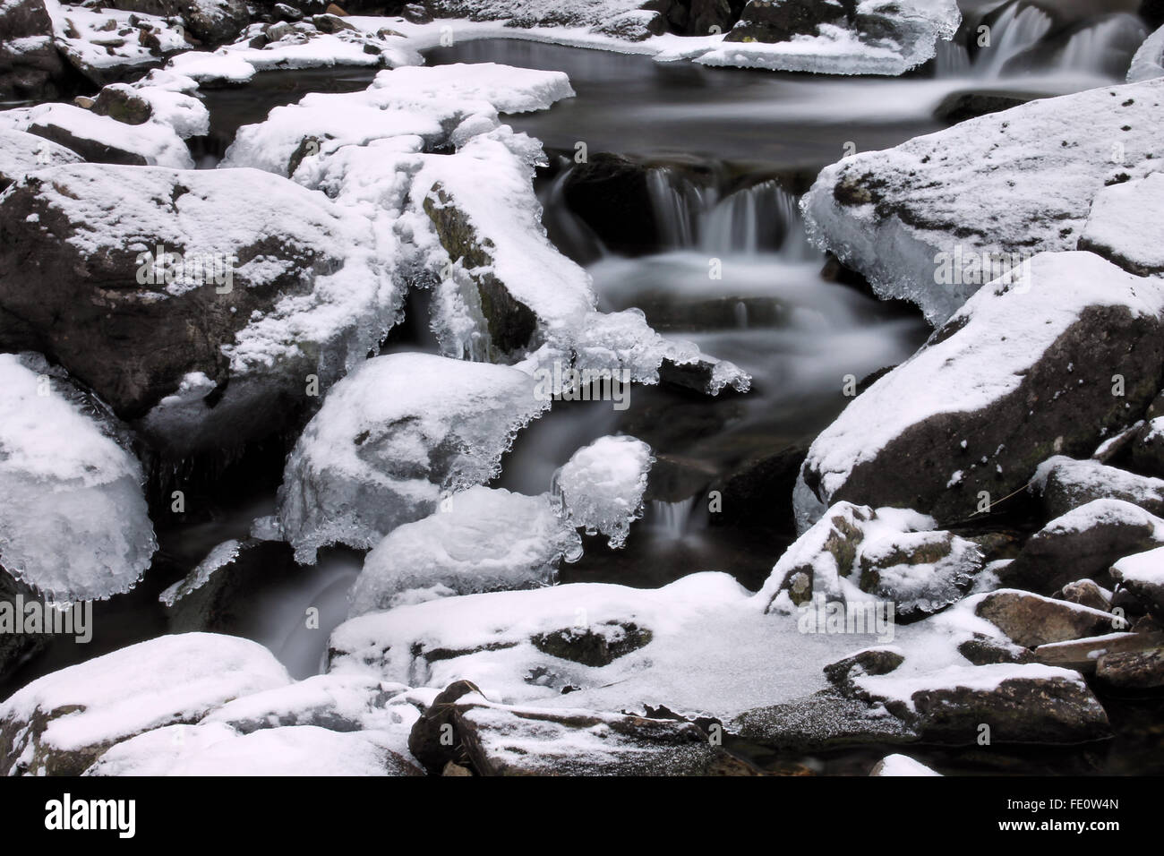 Ice and snow on rocks in a stream in the Ogwen valley Stock Photo - Alamy