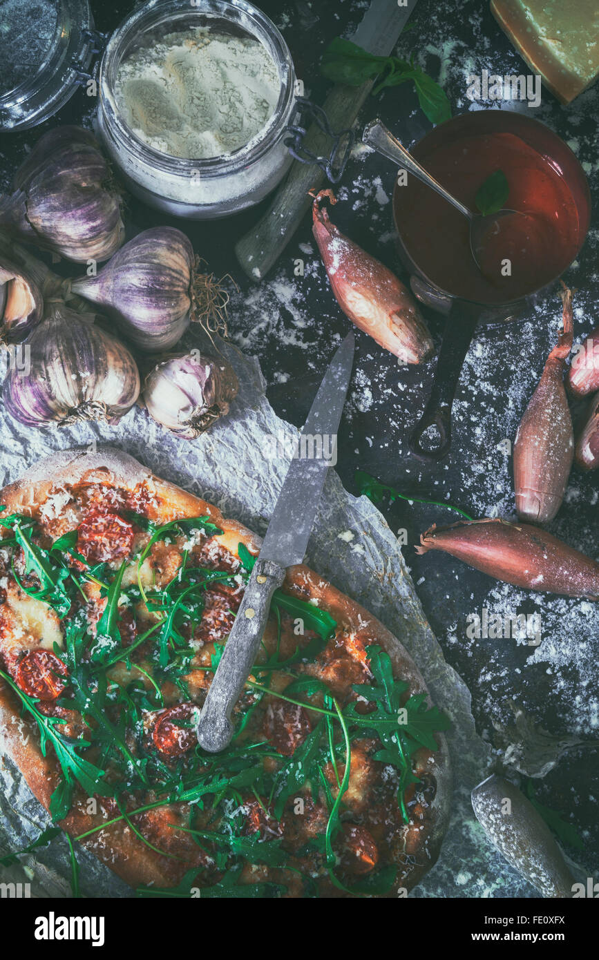 A homemade rustic pizza on a farmhouse kitchen table Stock Photo - Alamy
