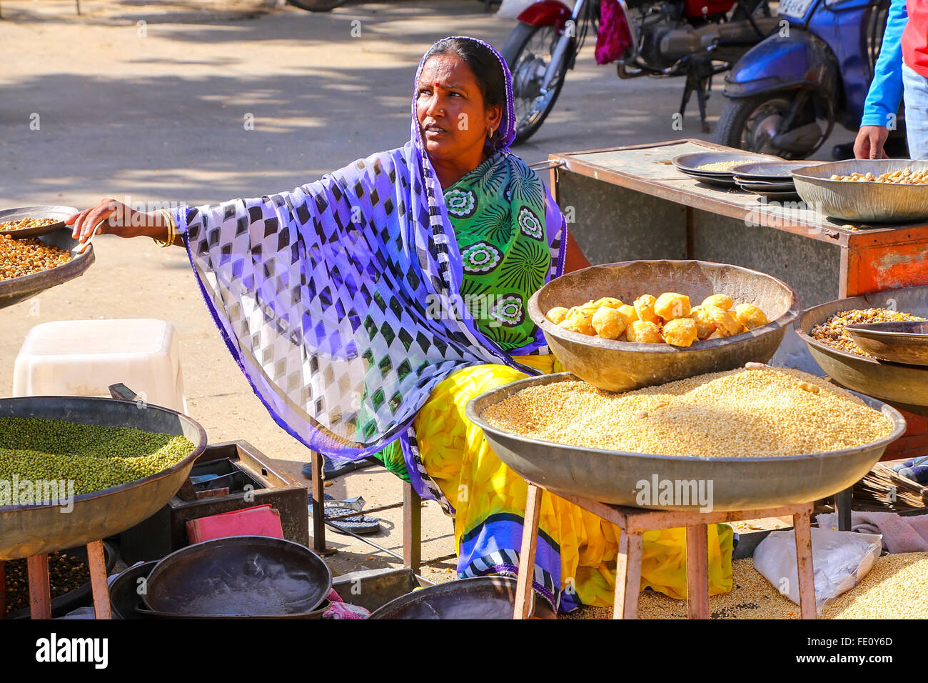 Indian woman selling food near City Palace in Jaipur, Rajasthan, India ...