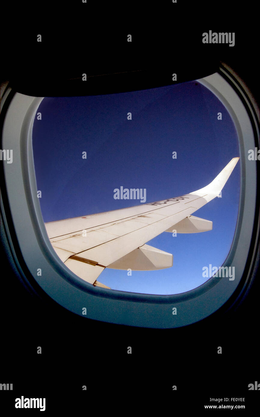 View of wing from seat inside airplane in flight Stock Photo - Alamy