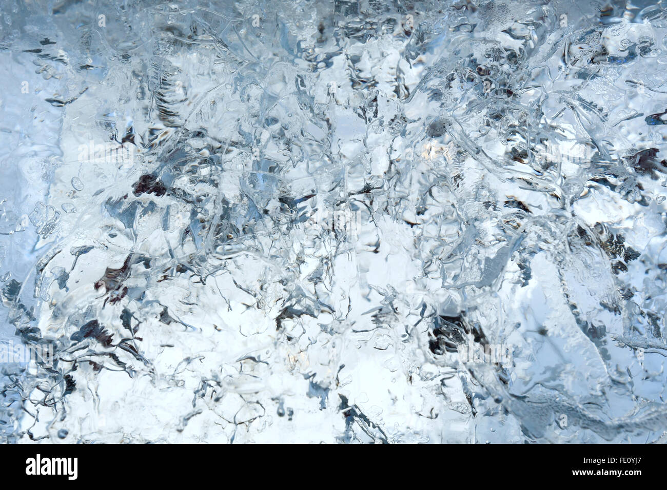 Glacial transparent wall of ice with interesting drawings and patterns ...