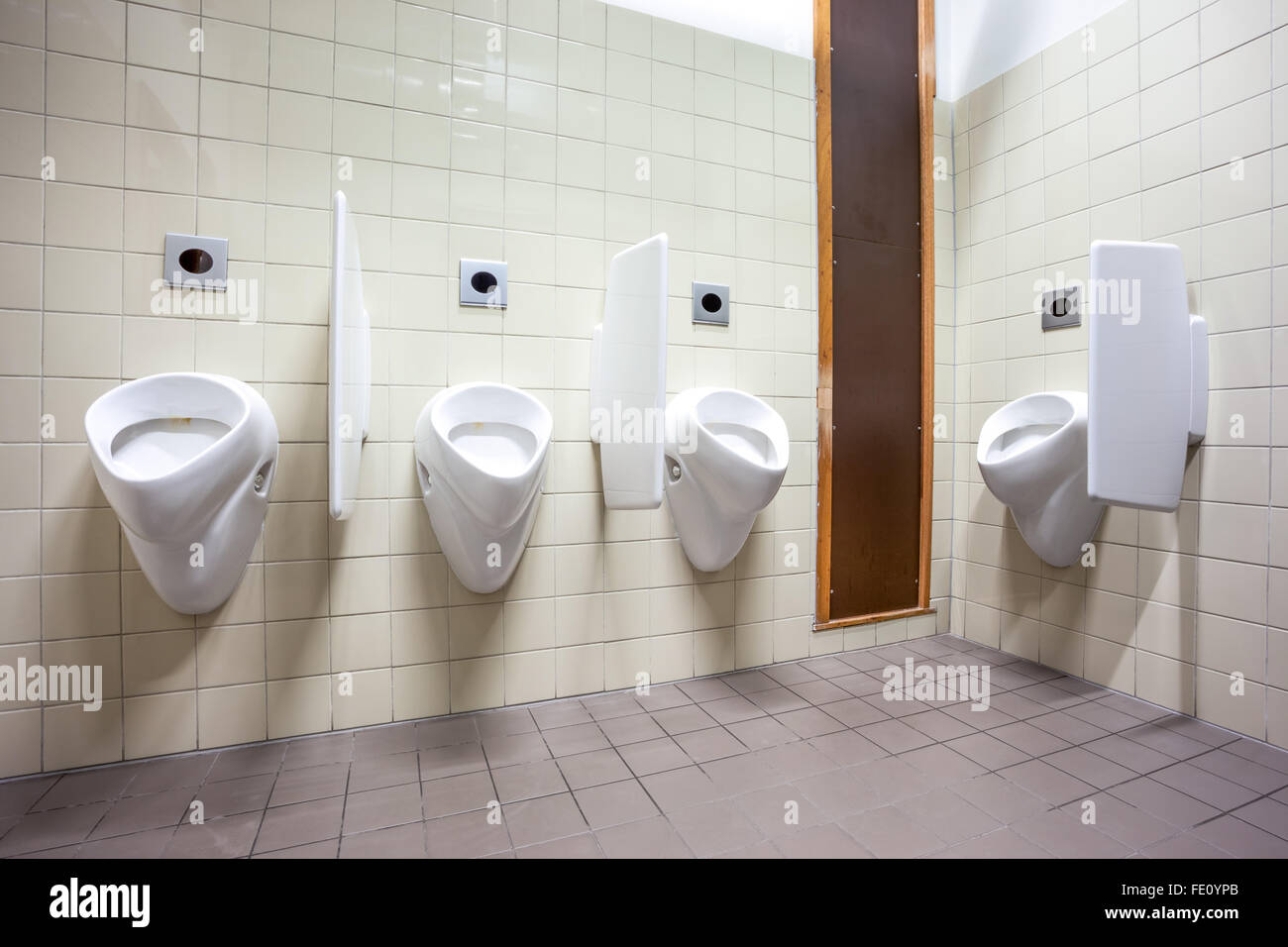 urinals in an old building for men only Stock Photo - Alamy