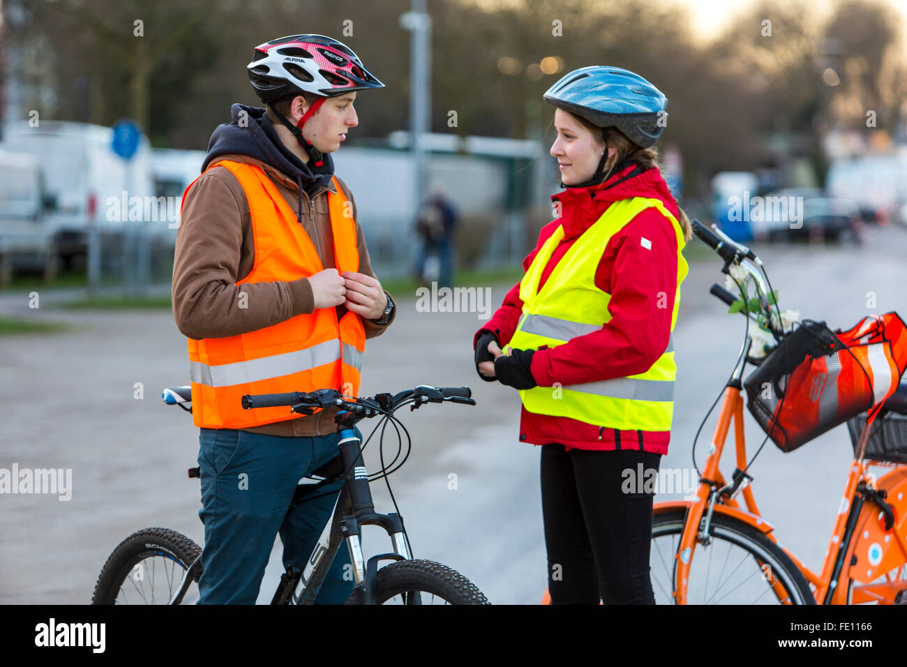 Cyclist put on safety clothing, bike helmet and reflecting vest for ...