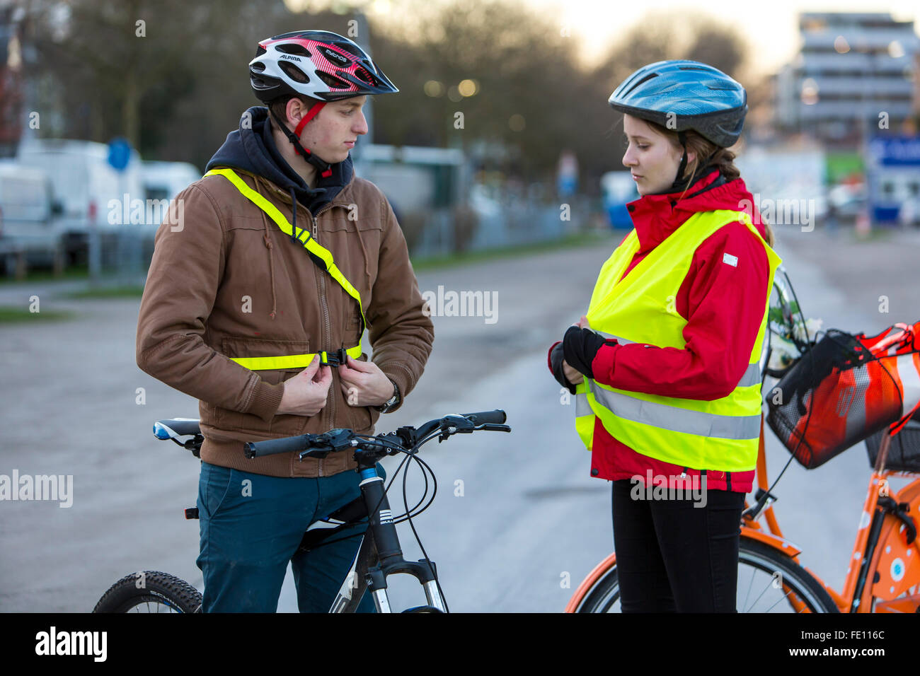 Cyclist put on safety clothing, bike helmet and reflecting vest for ...