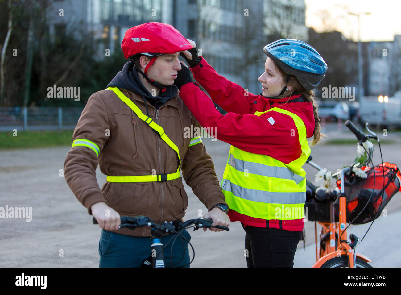 Cyclist put on safety clothing, bike helmet and reflecting vest for ...