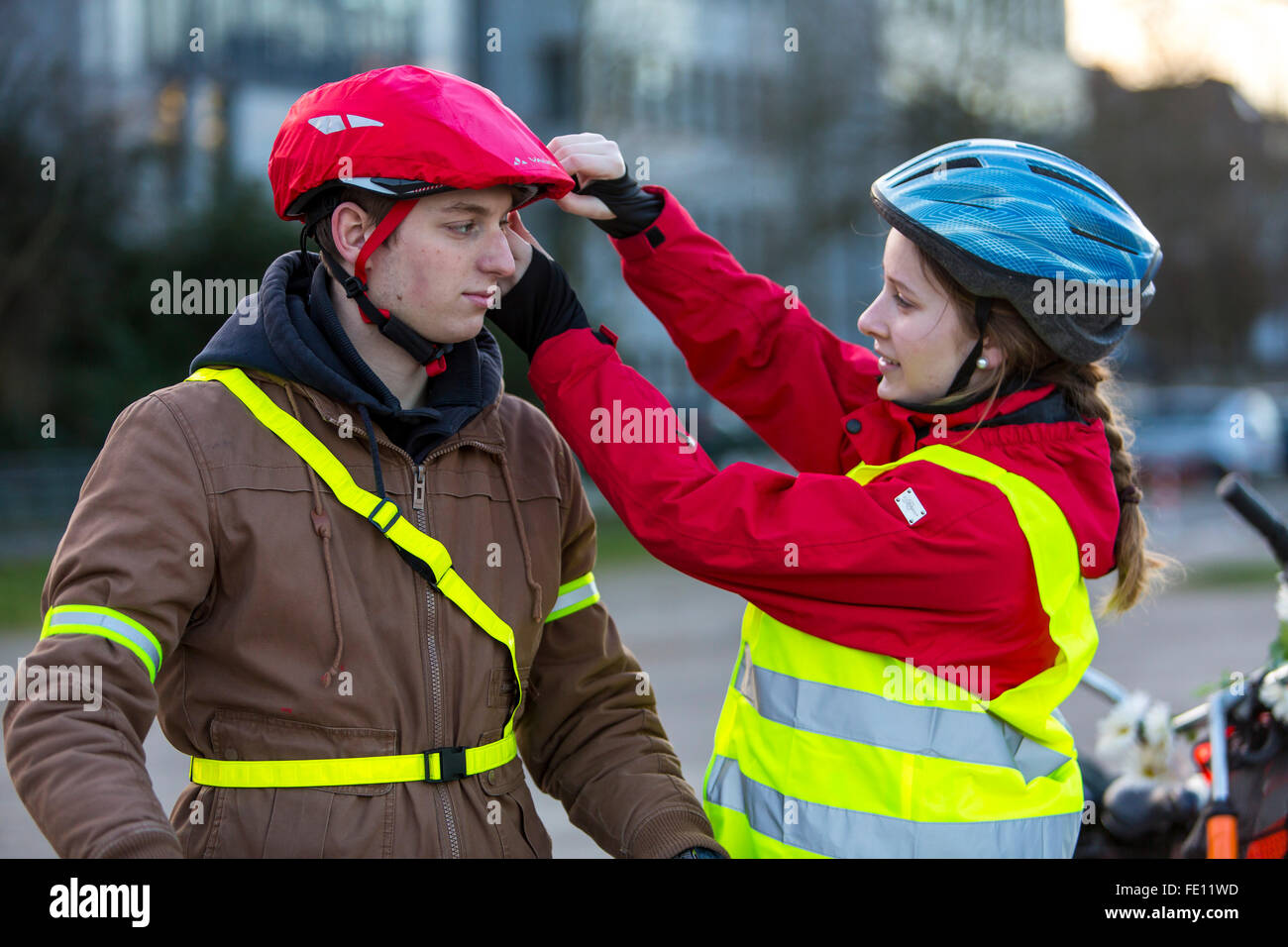 Cyclist put on safety clothing, bike helmet and reflecting vest for ...