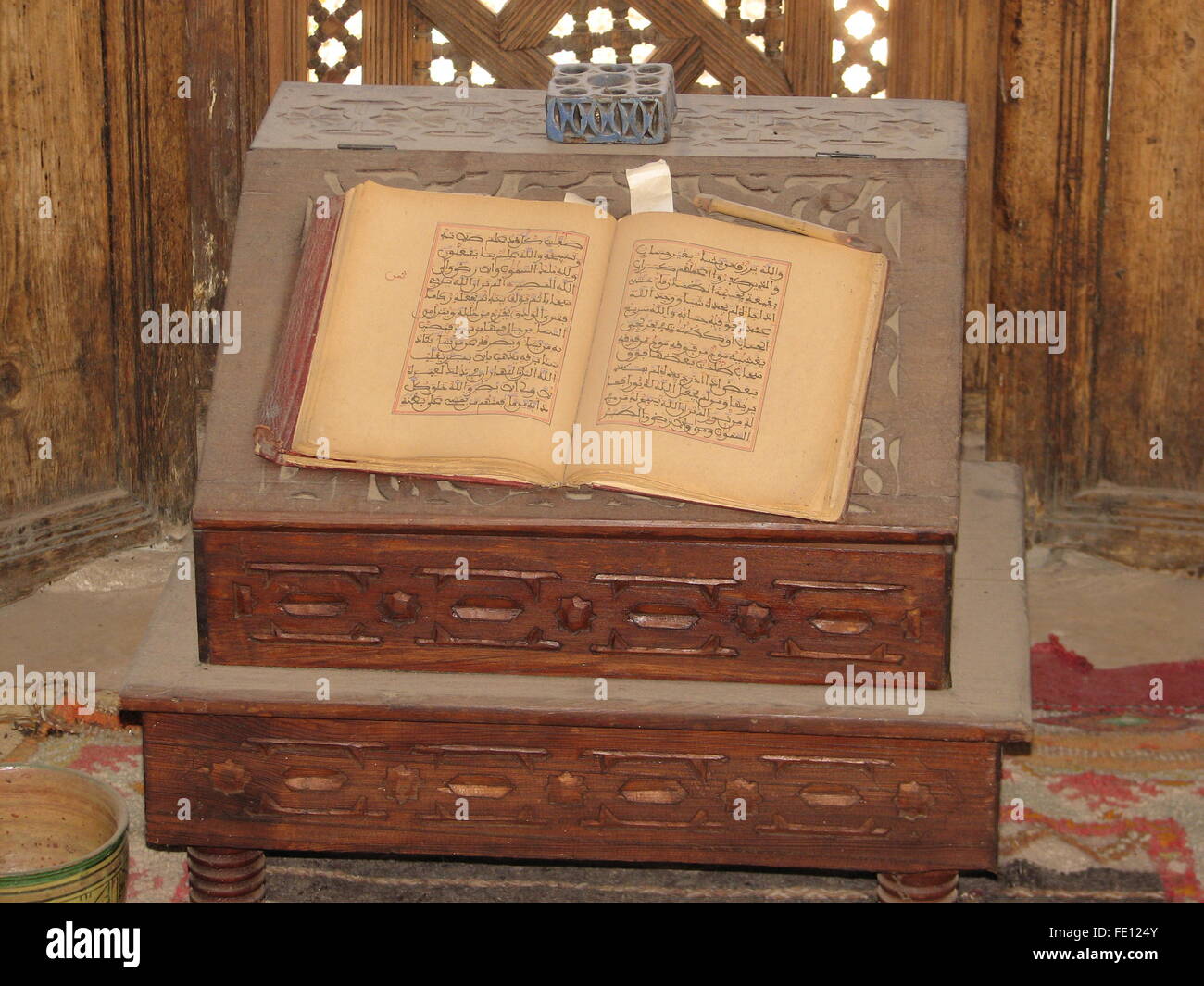 A student's floor desk with pages of the Quran at the student's room at ...