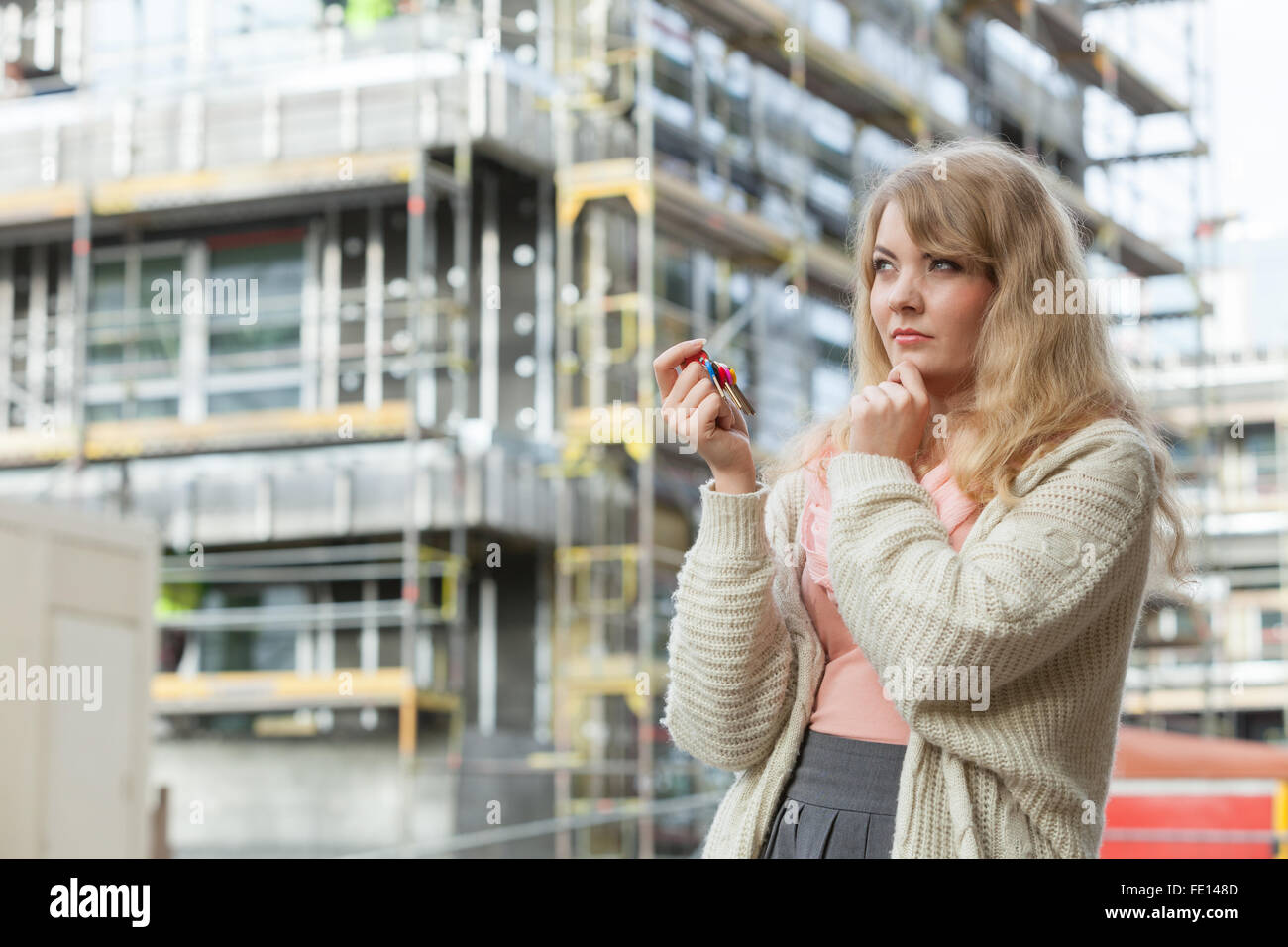 Real estate concept - young woman on front of new big modern house ...